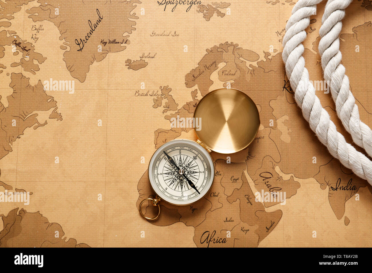 Vintage compass with rope on world map Stock Photo - Alamy