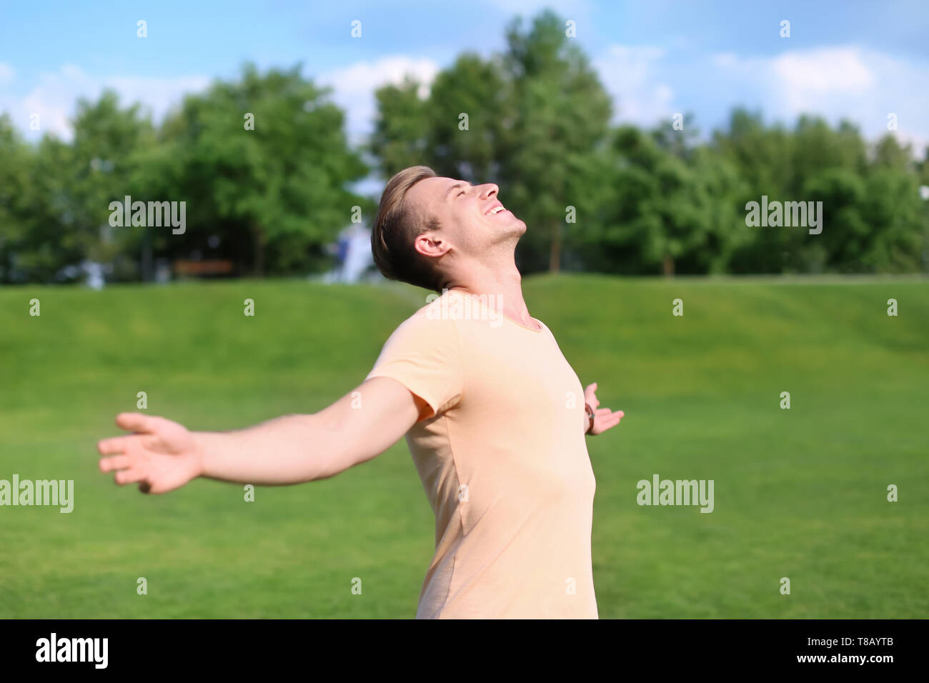 Carefree young man raising hands hi-res stock photography and images ...