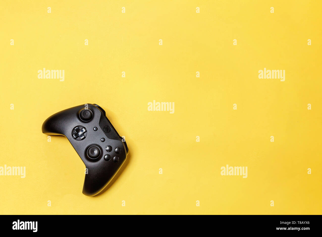 Black joystick gamepad, game console on yellow colourful trendy modern ...