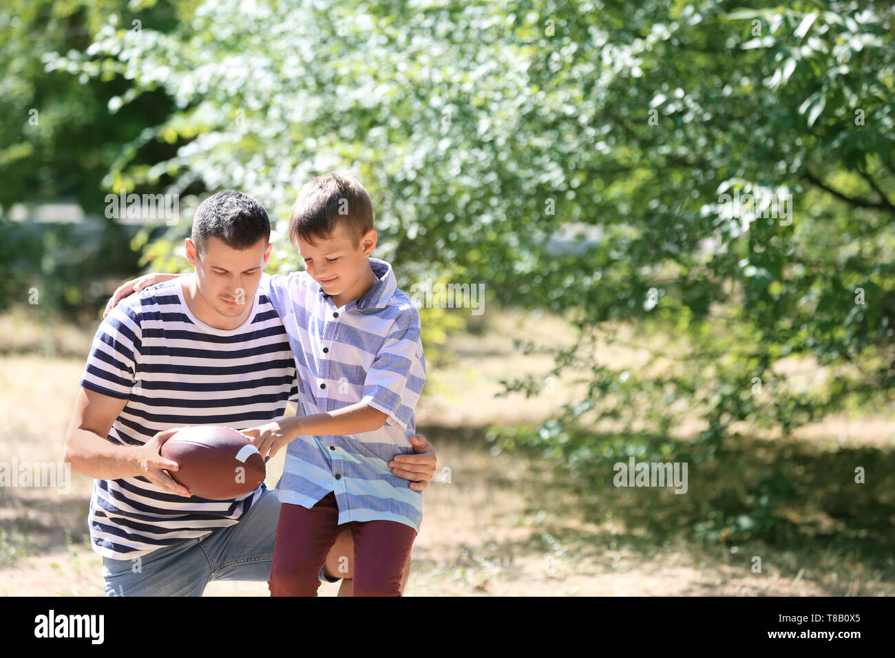 Dad and son playing rugby hi-res stock photography and images - Alamy