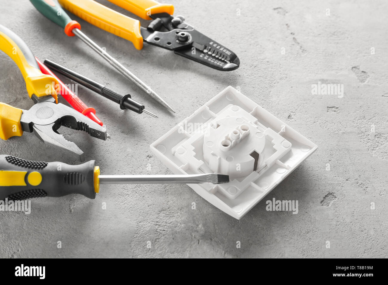 Different electrician's tools with socket on light background Stock ...