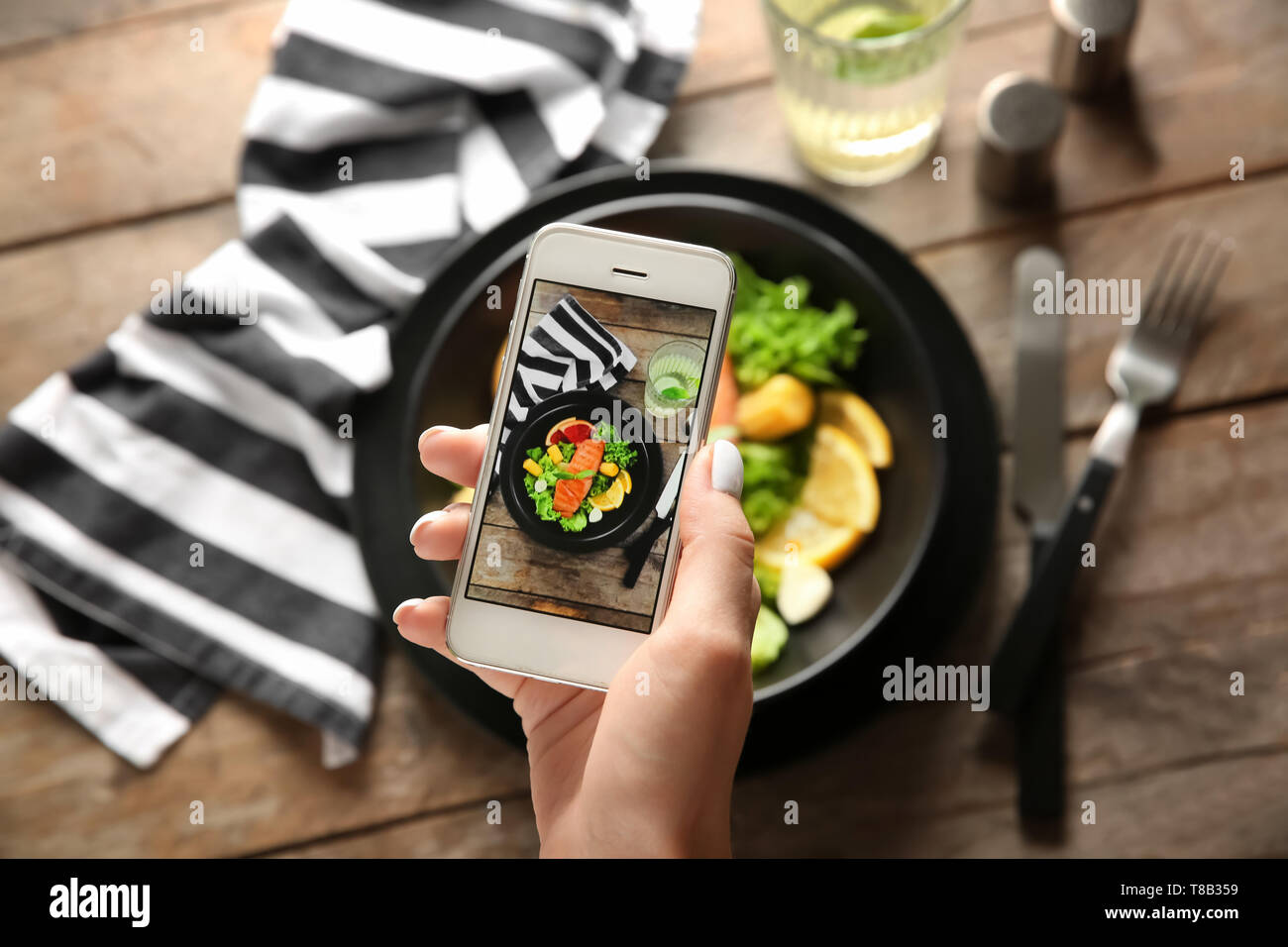 Woman taking photo of diet food with mobile phone Stock Photo - Alamy