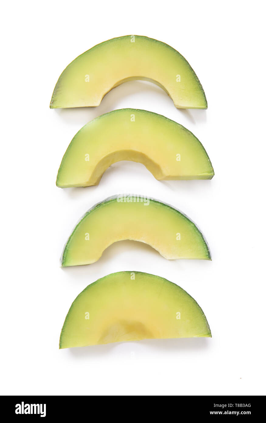 Slices of avocado on white background Stock Photo - Alamy