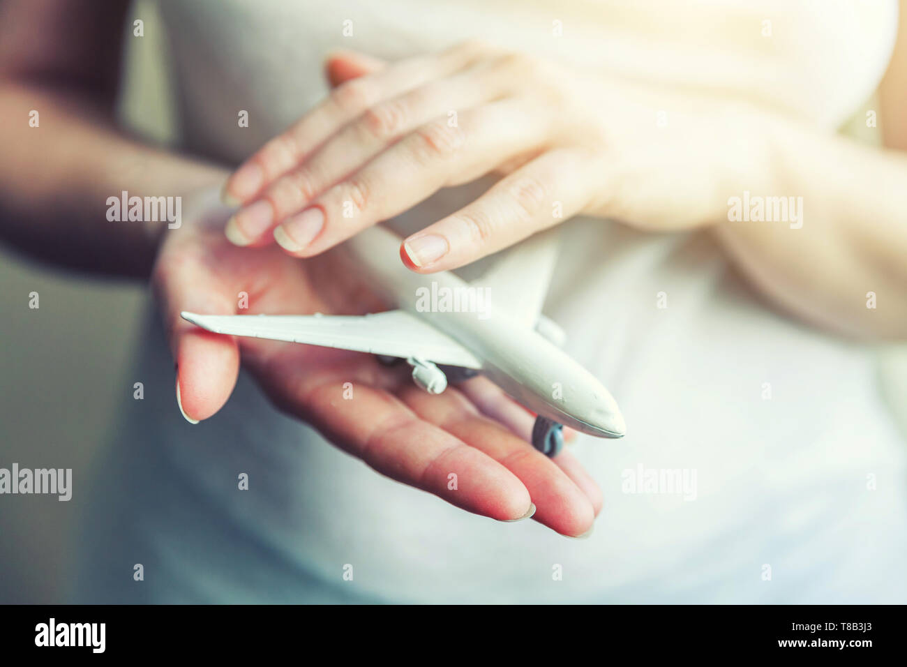Female woman hands holding small toy model plane. Travel by plane ...