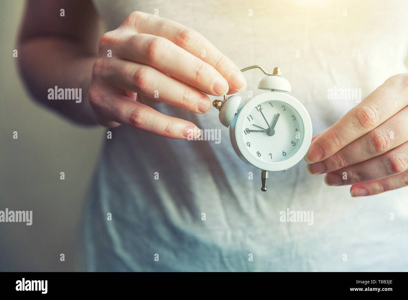 Female woman hands holding ringing twin bell vintage classic alarm ...