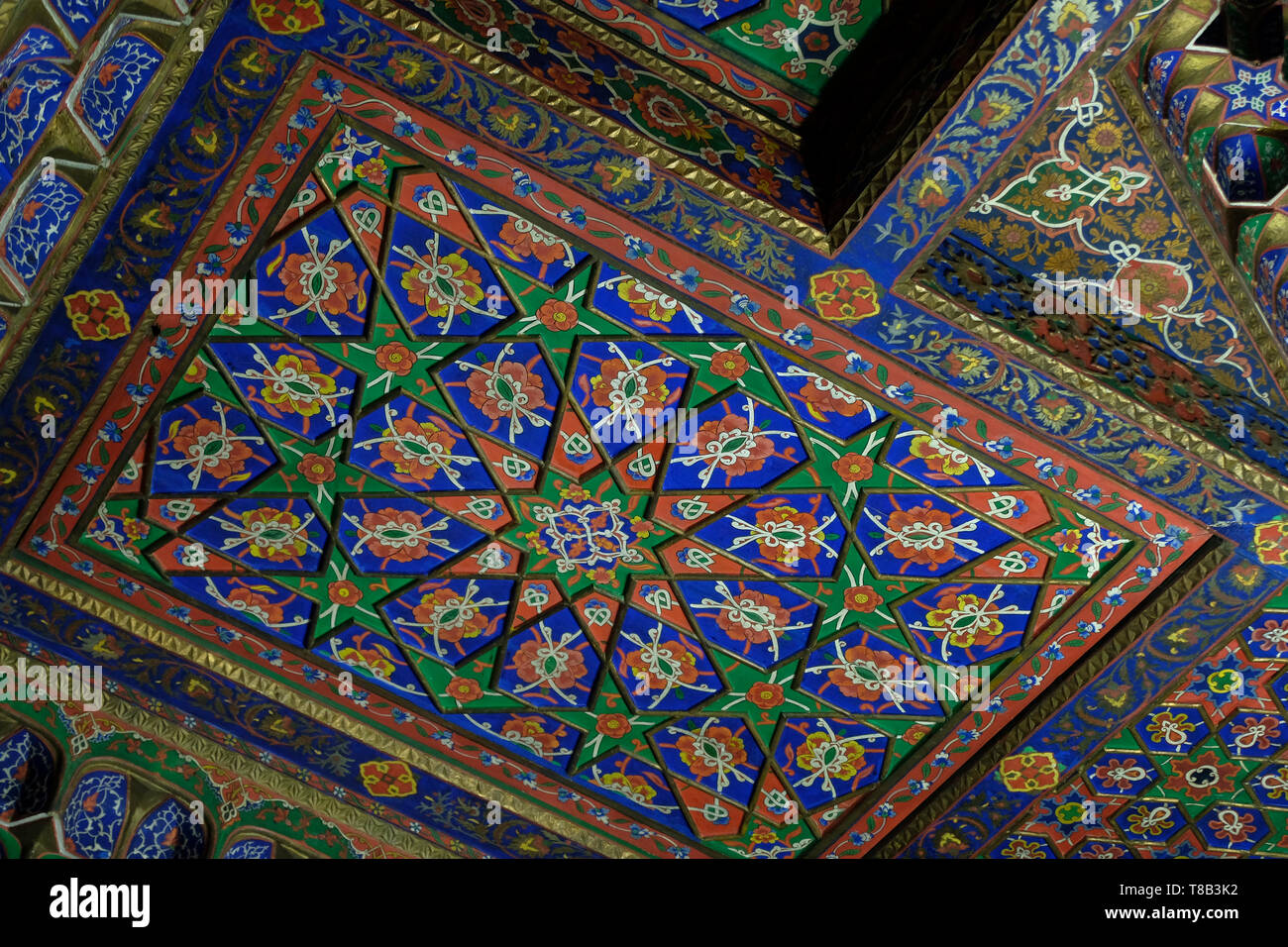 Ornately carved and vividly painted ceiling in typical Tajik style of ...