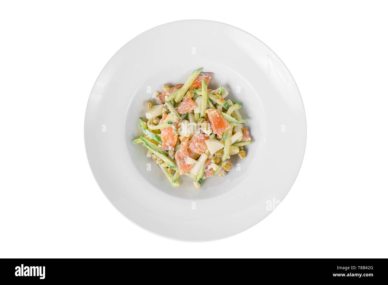 Russian salad with fish salmon, cucumber, peas, eggs, mayonnaise on ...