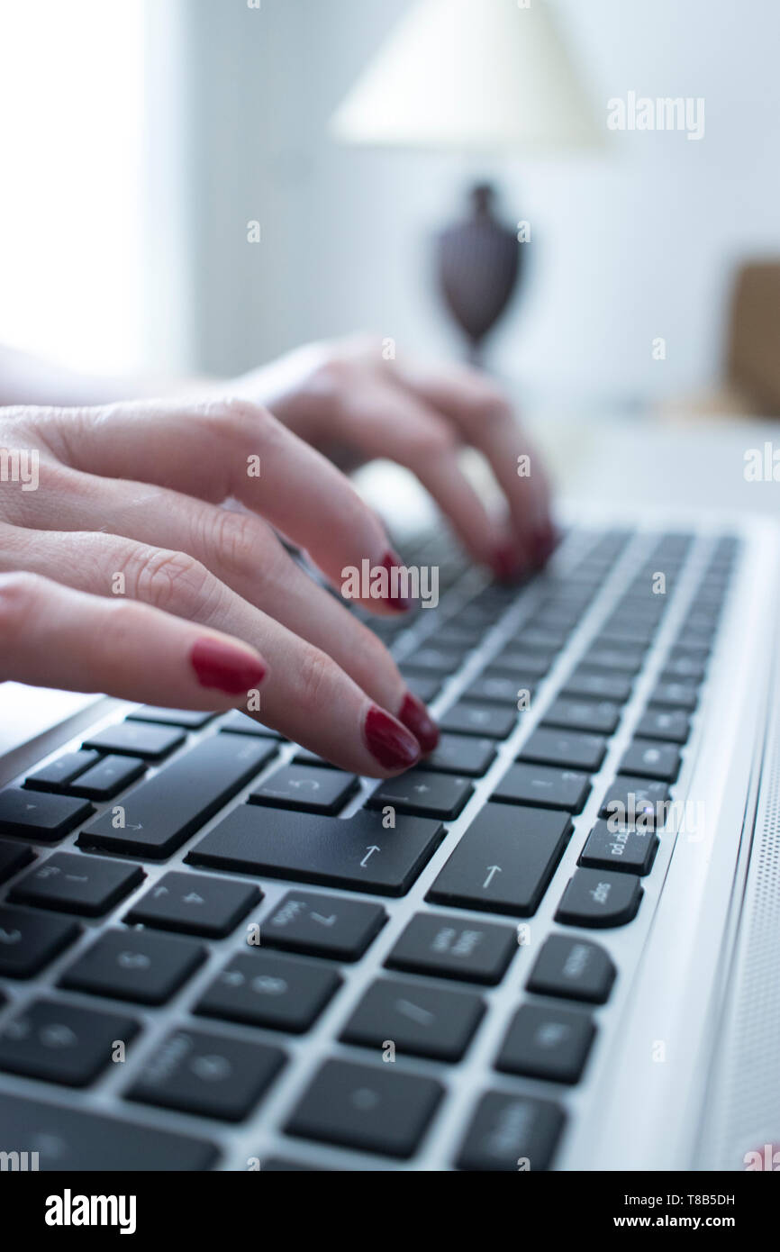 Secretary typist typing on laptop pc computer keyboard keys with hands ...