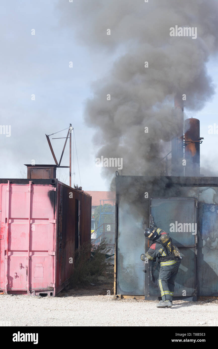 Firefighter putting out fire training station extinguisher backdraft ...
