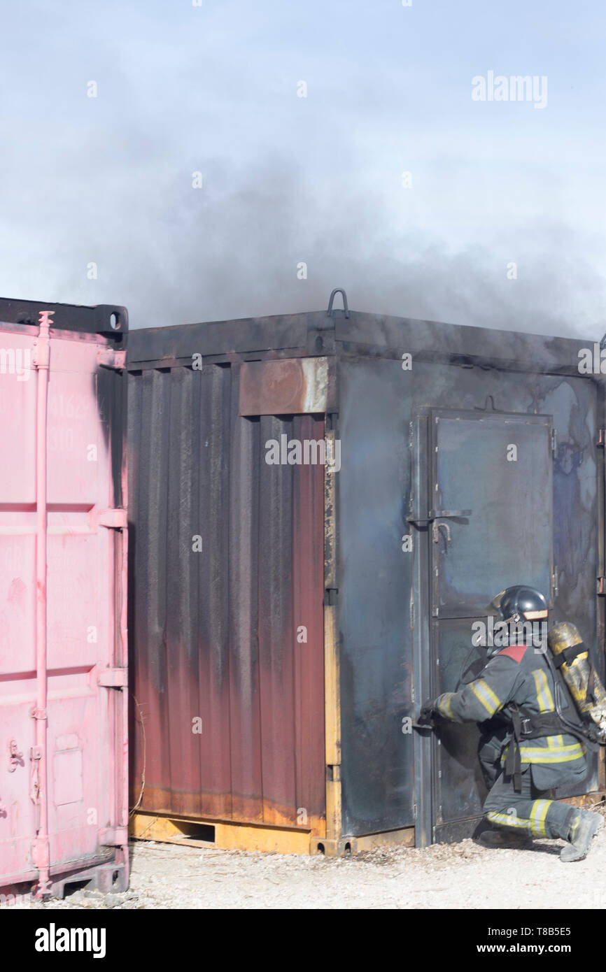 Firefighter putting out fire training station extinguisher backdraft ...