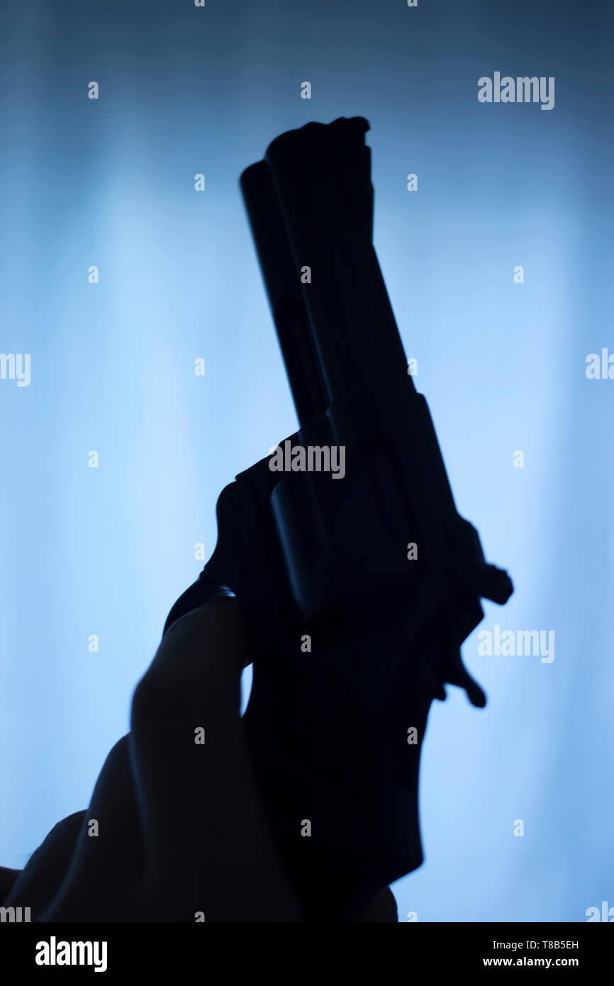 Pistol automatic handgun weapon in silhouette in hand of killer ...