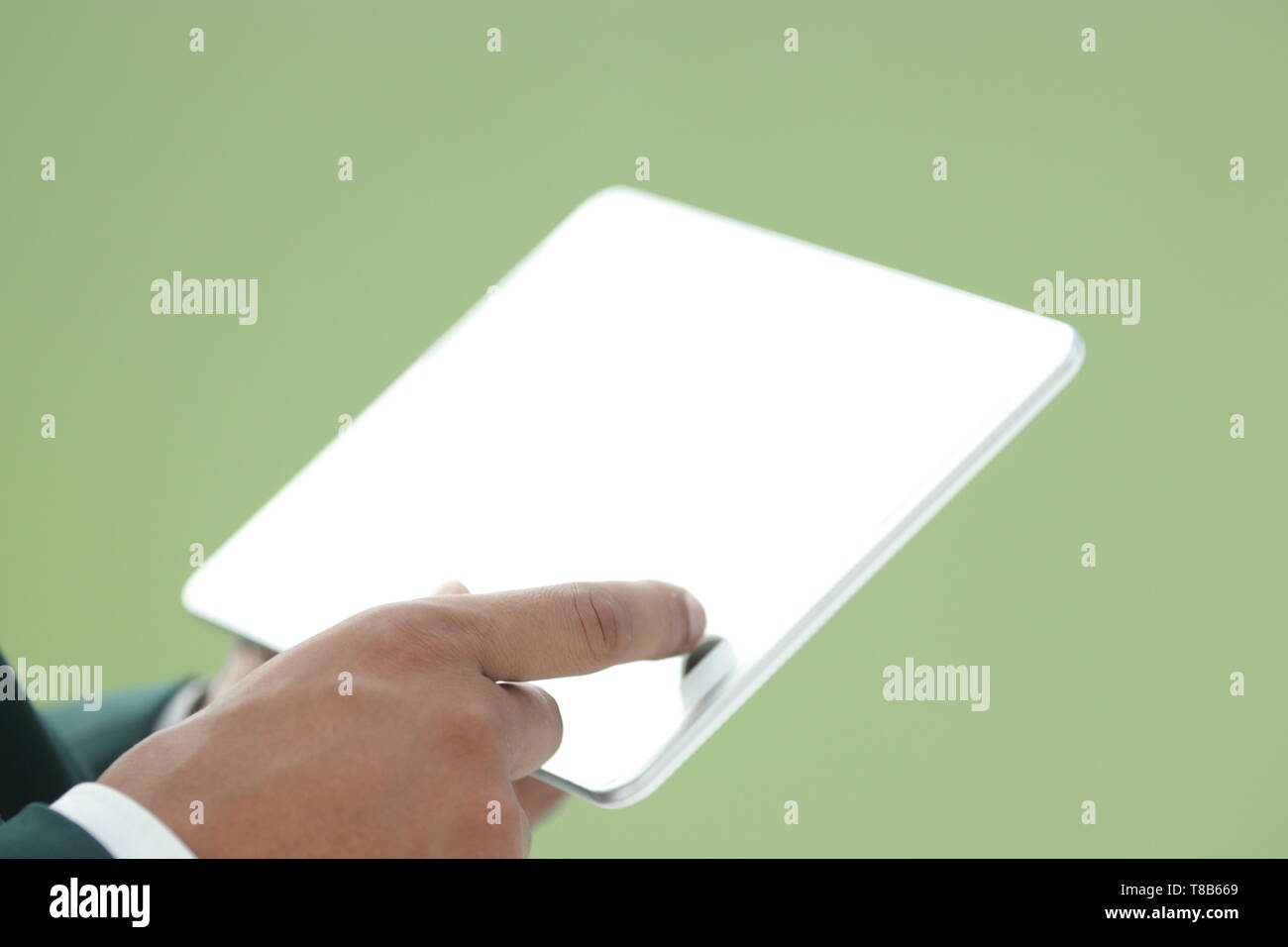 close up.businessman tapping the screen of the digital tablet . people ...