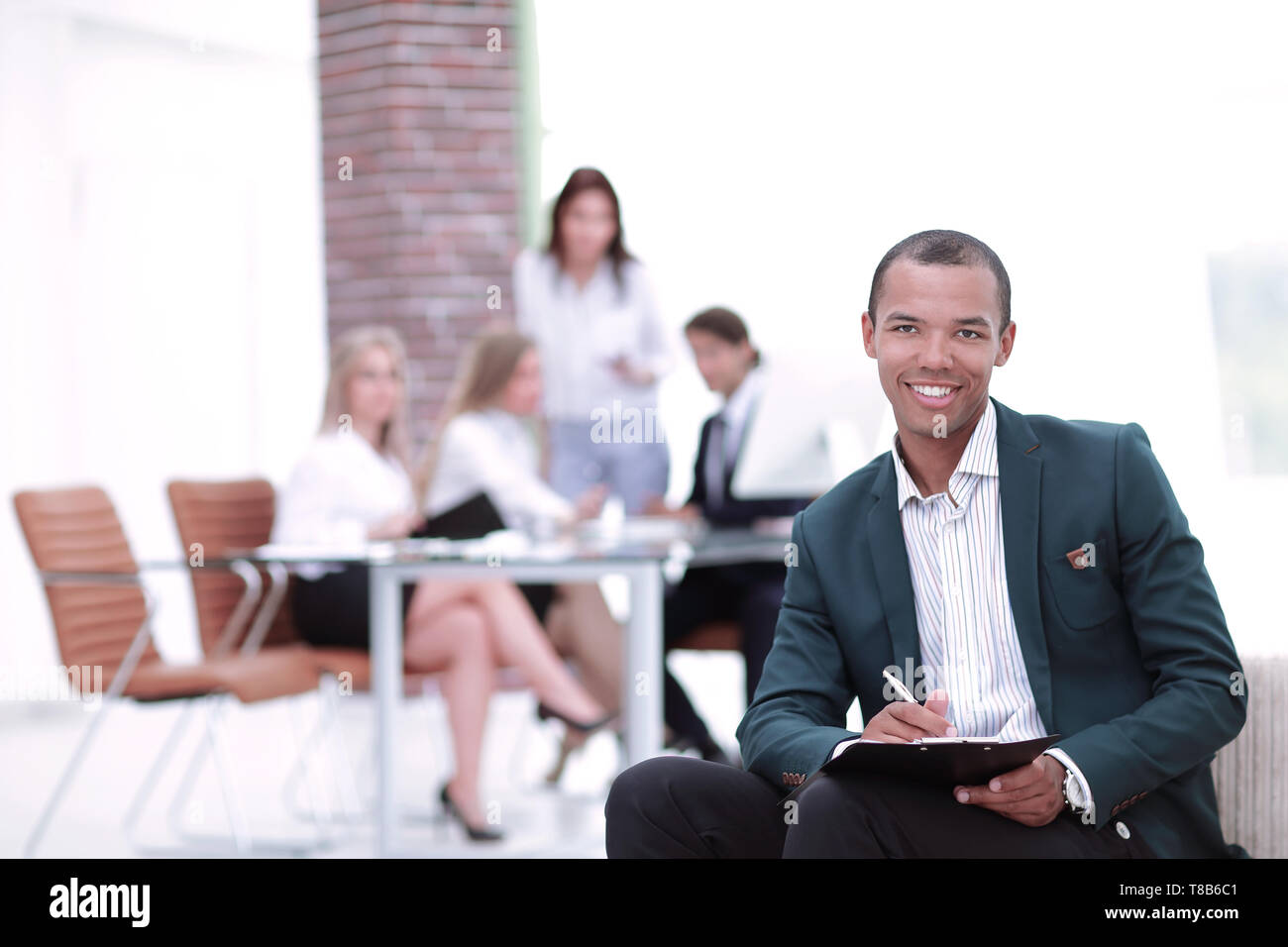 young businessman signing a document in his office.photo with copy ...