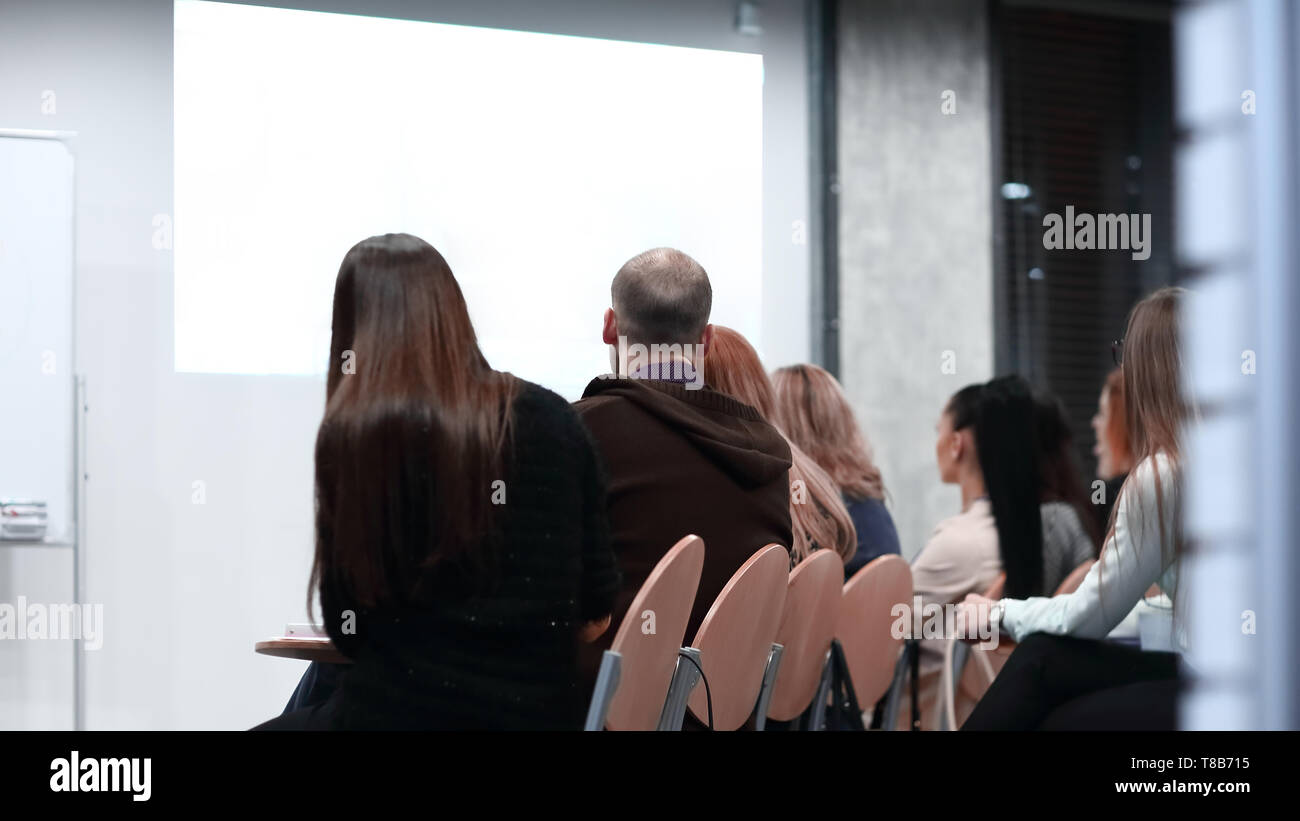 audience in the conference room looking at a blank screen.photo with ...