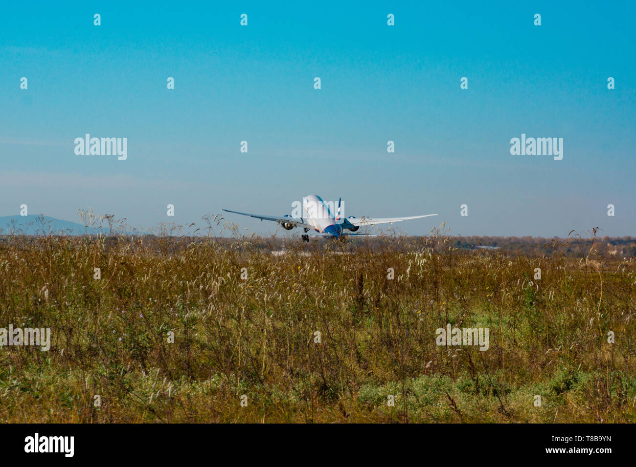 The plane takes off at dawn at high speed. Photo from the runway ...