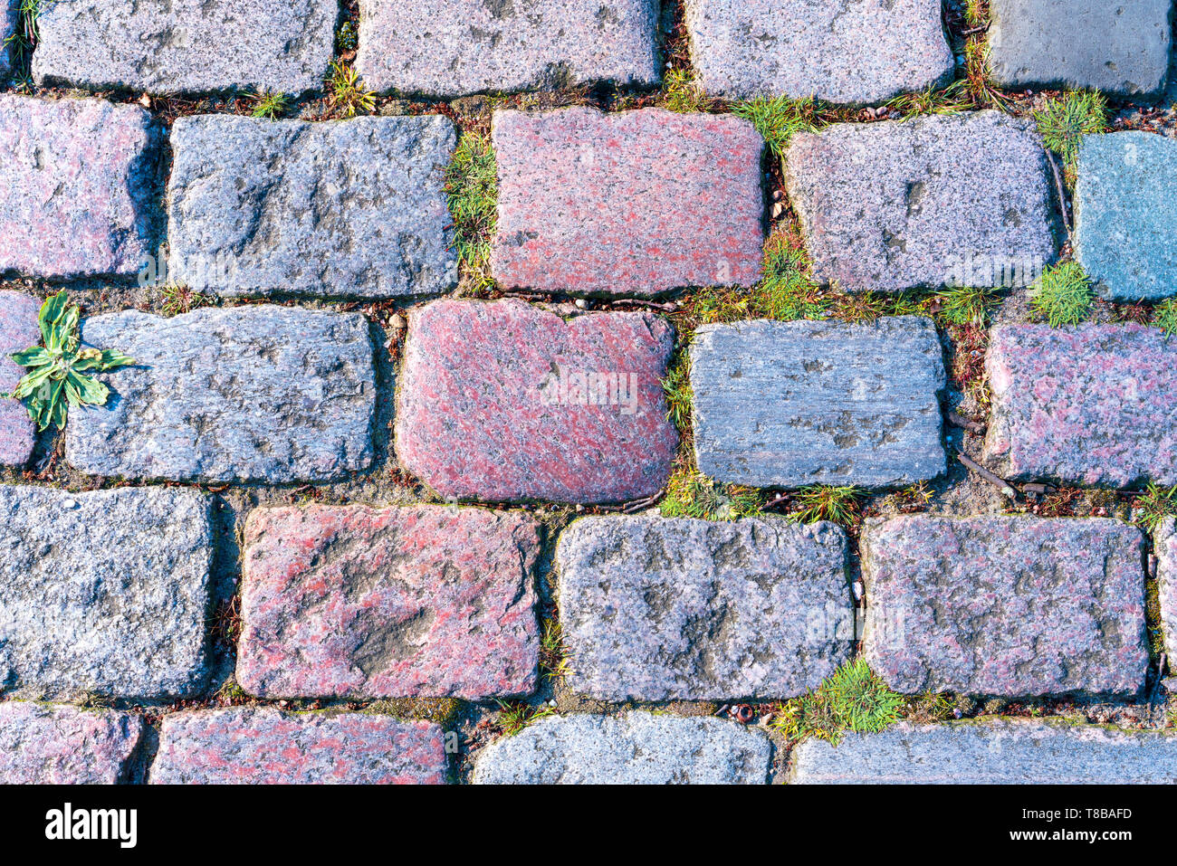 Multi-colored beautifully folded pavers. Old multi-colored stone blocks ...