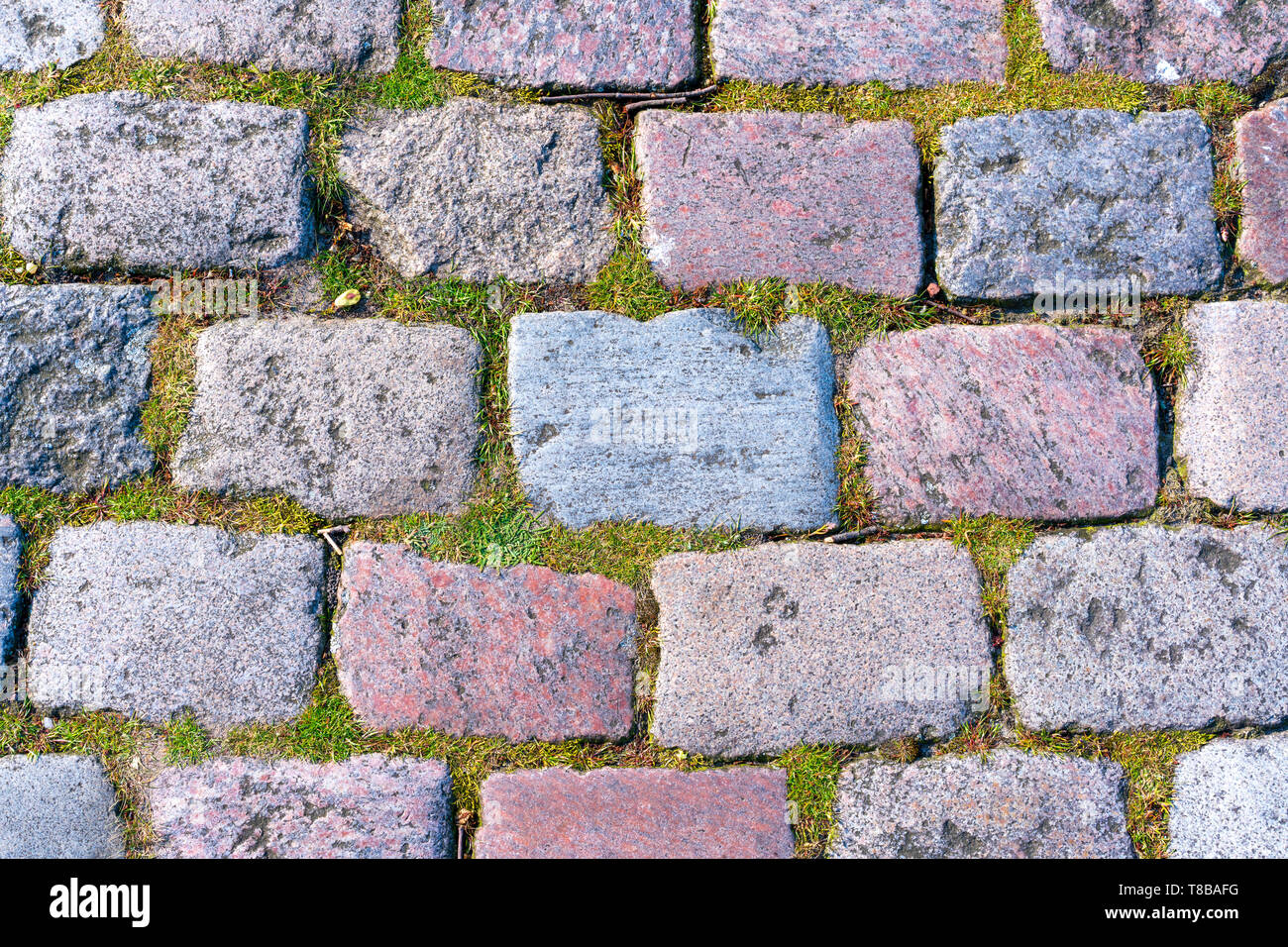 Multi-colored beautifully folded pavers. Old multi-colored stone blocks ...