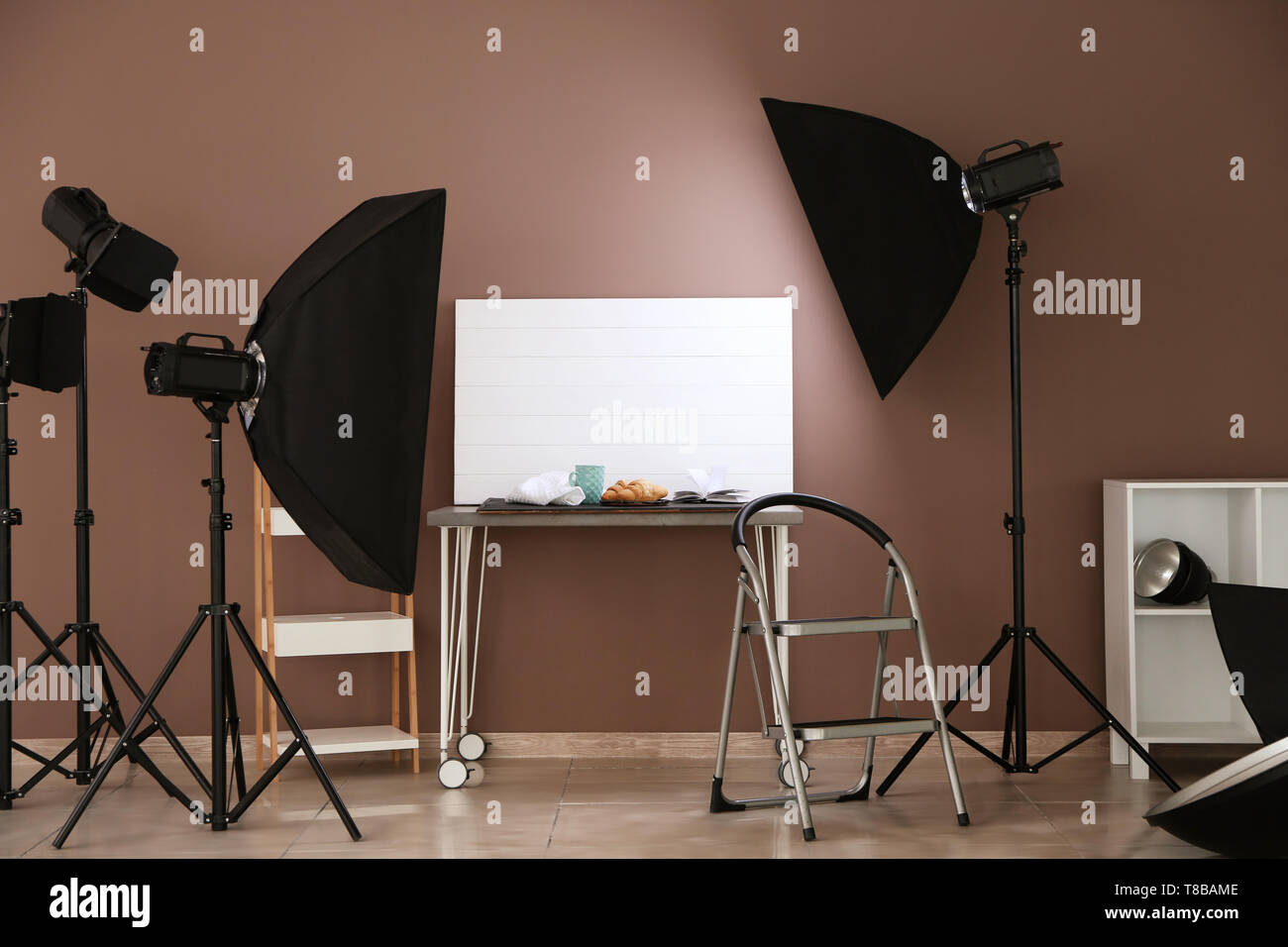 Interior of modern photo studio with professional equipment and table ...