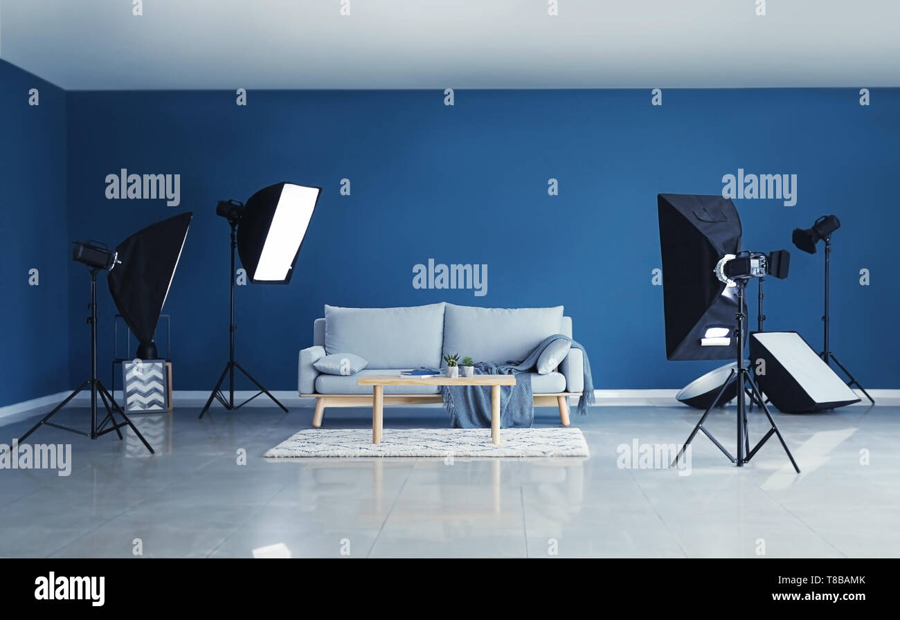 Interior of modern photo studio with professional equipment and sofa ...