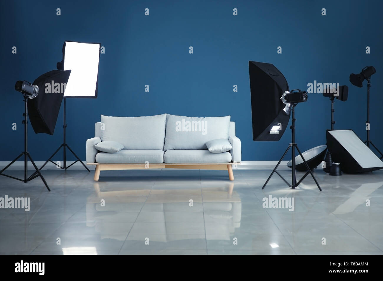 Interior of modern photo studio with professional equipment and sofa ...
