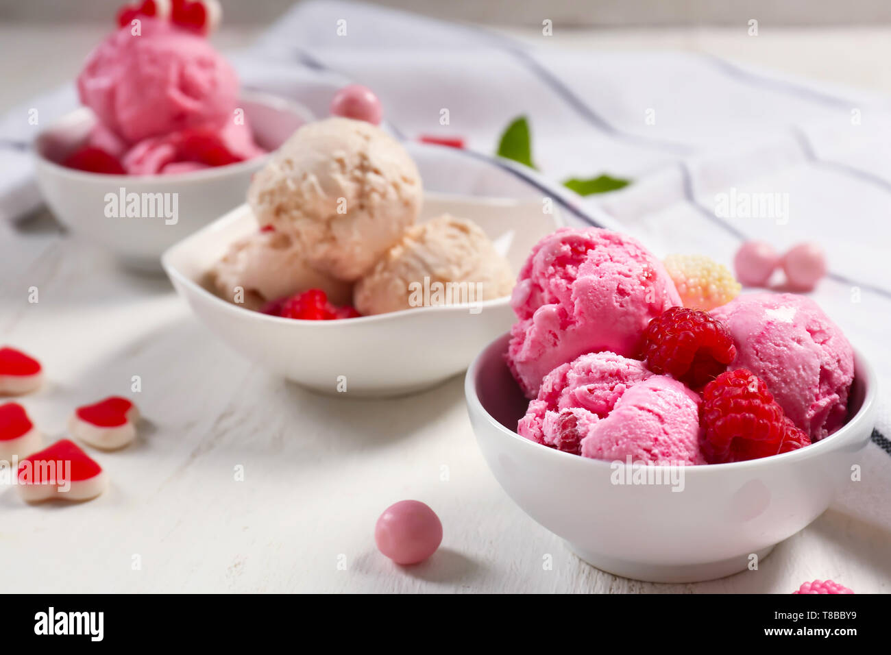 Bowls with delicious raspberry ice-cream on wooden table Stock Photo ...