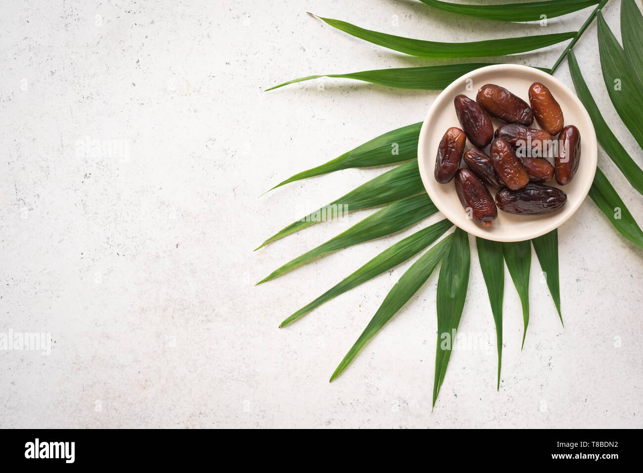Dates fruits on plate on white background, top view, copy space ...