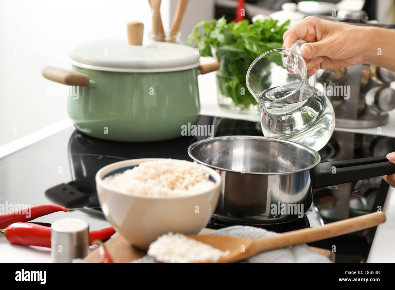 Hand pouring rice hi-res stock photography and images - Alamy