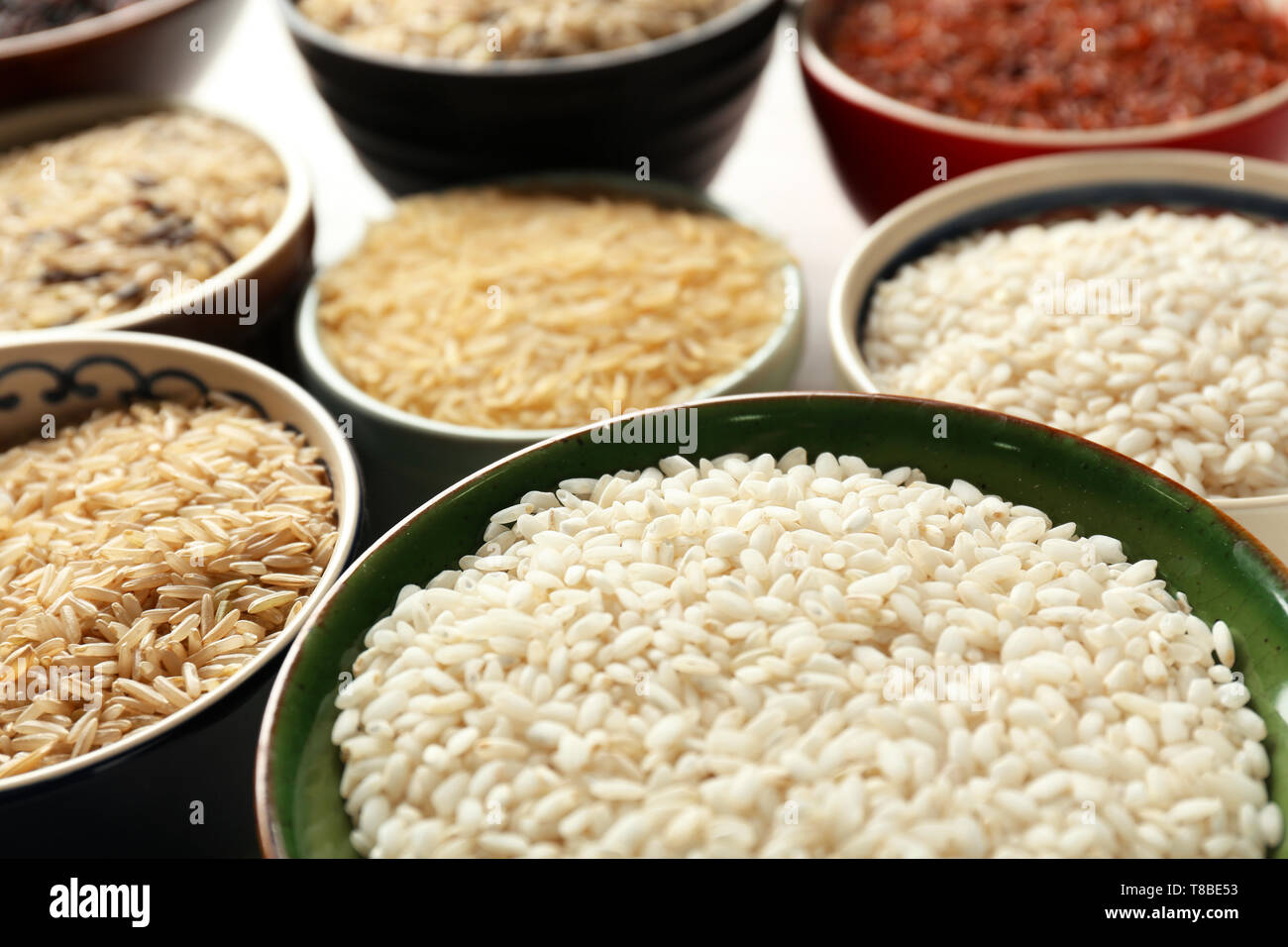 Different types of rice in bowls on table Stock Photo - Alamy