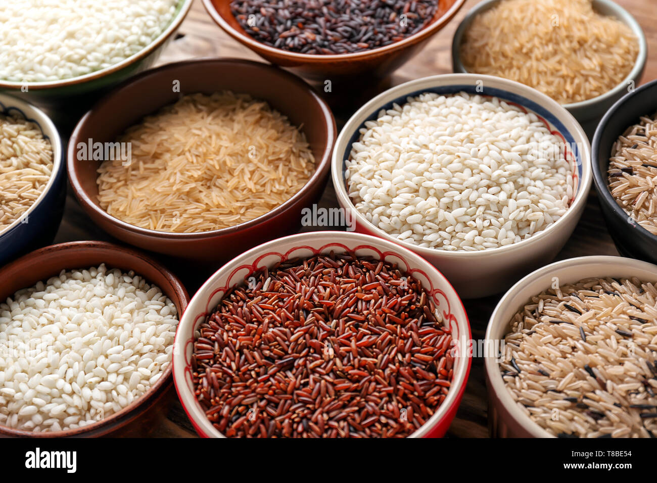 Different types of rice in bowls on table Stock Photo - Alamy