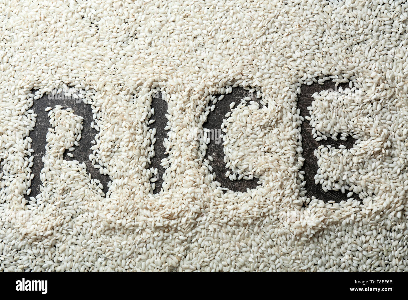 Word RICE made with grains on grey background Stock Photo - Alamy