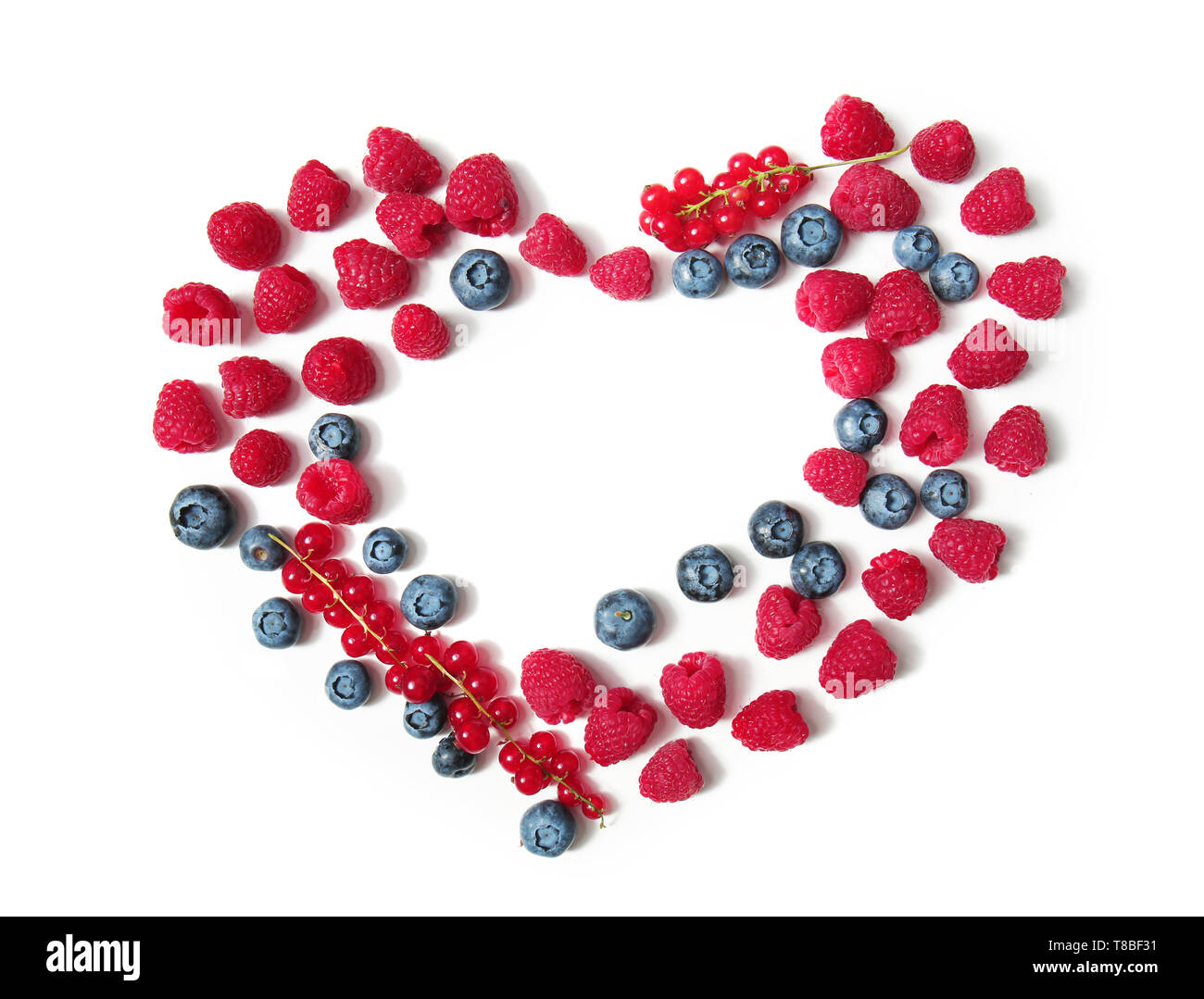Heart made of delicious ripe berries on white background Stock Photo ...