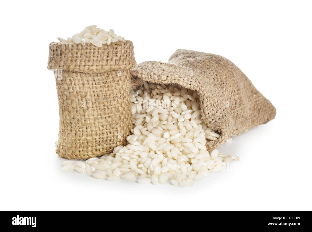 Bags with white rice on white background Stock Photo - Alamy