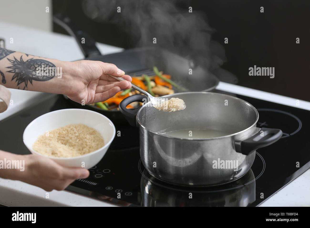 Rice boiling in saucepan hi-res stock photography and images - Alamy