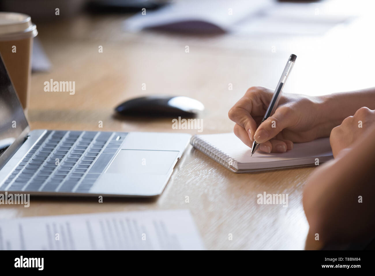 Close up female hands holding pen writing in notepad Stock Photo - Alamy