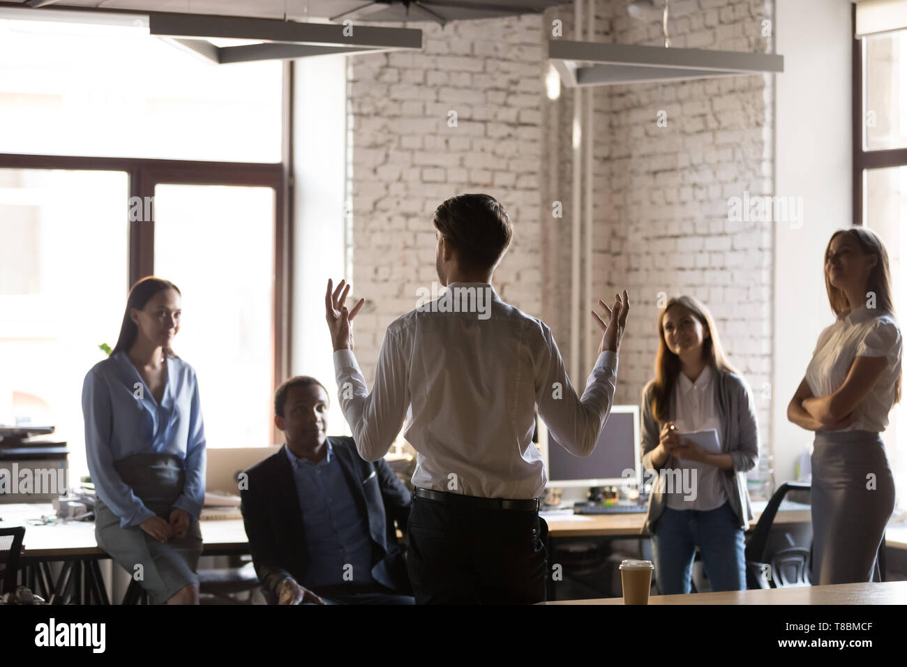 Diverse employees listening team leader during briefing Stock Photo - Alamy