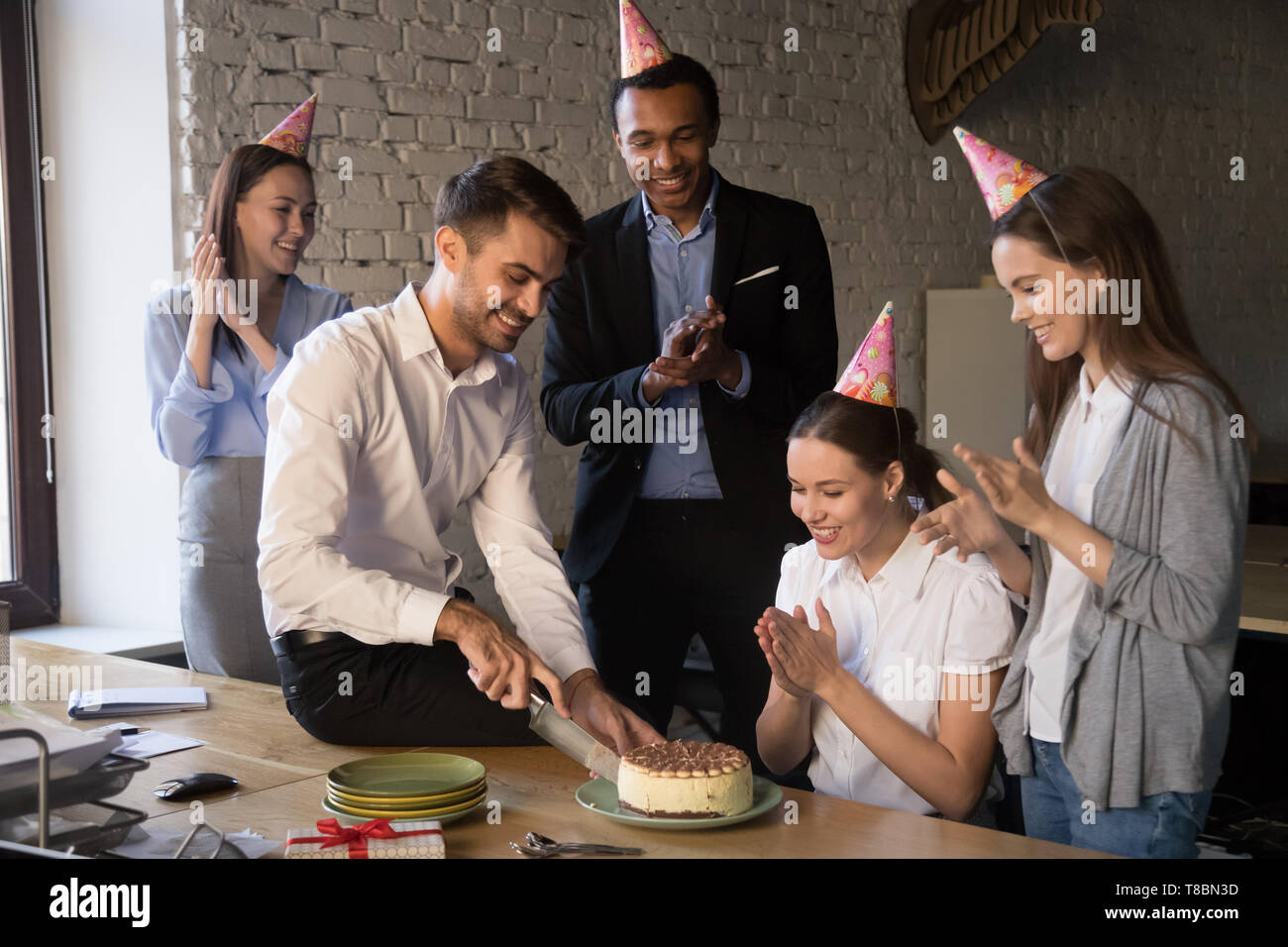 Happy joyful diverse colleagues celebrating birthday of workmate Stock ...