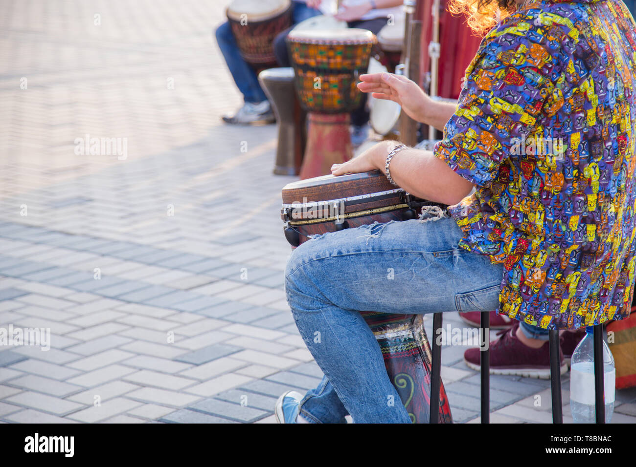 Man playing ethnic drum on street Stock Photo - Alamy