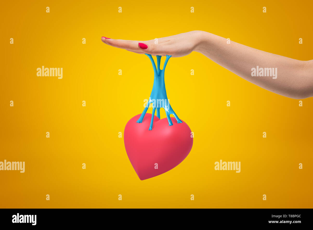 Female hand with pink heart stuck to it with blue sticky slime on ...