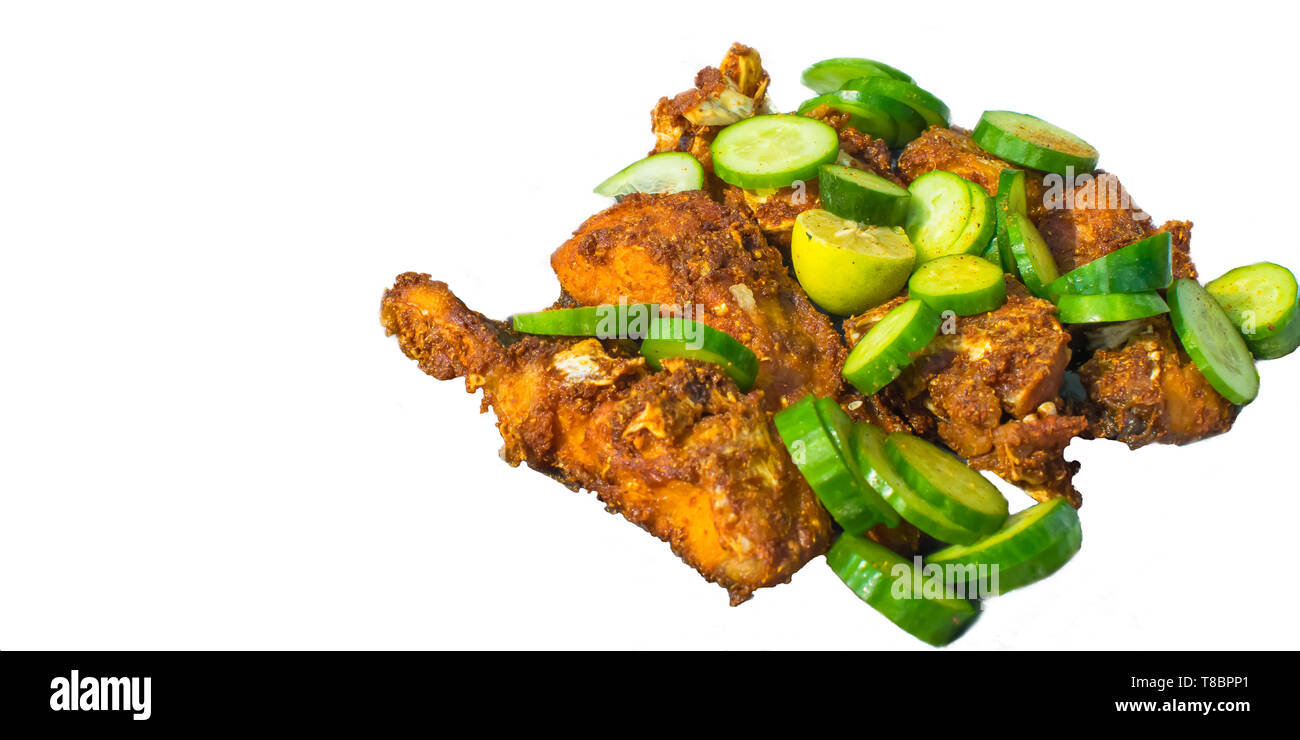close up of fried fish with lemon and cucumber.a tipical dish of indus ...