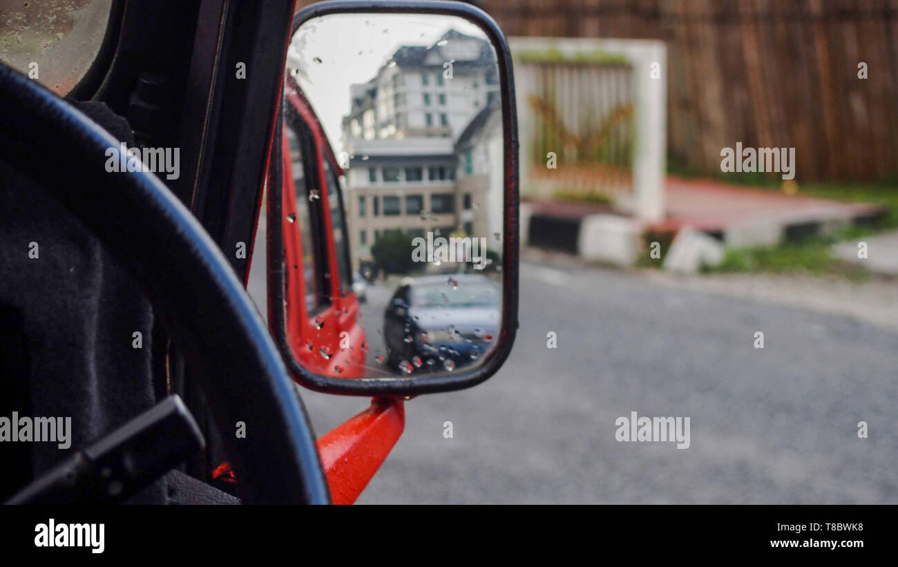 Side mirror of a red car reflecting a building Stock Photo - Alamy