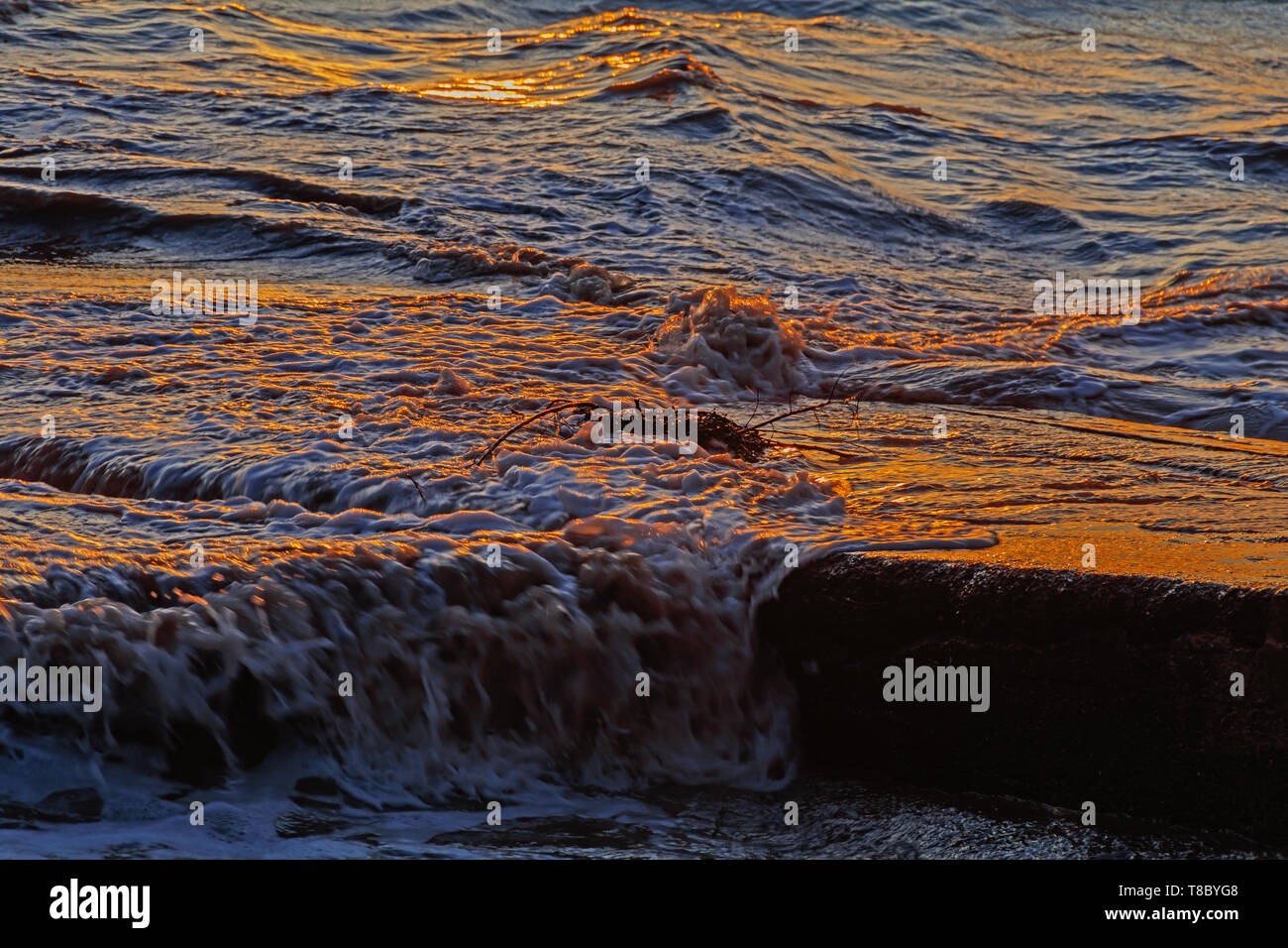 Sea lapping over the slipway Stock Photo - Alamy