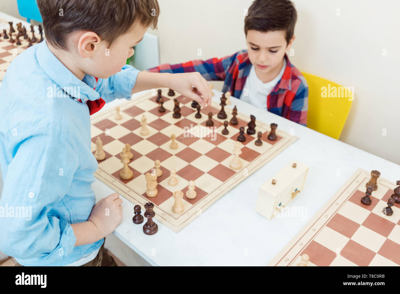 Two boys playing chess in tournament as sport Stock Photo - Alamy