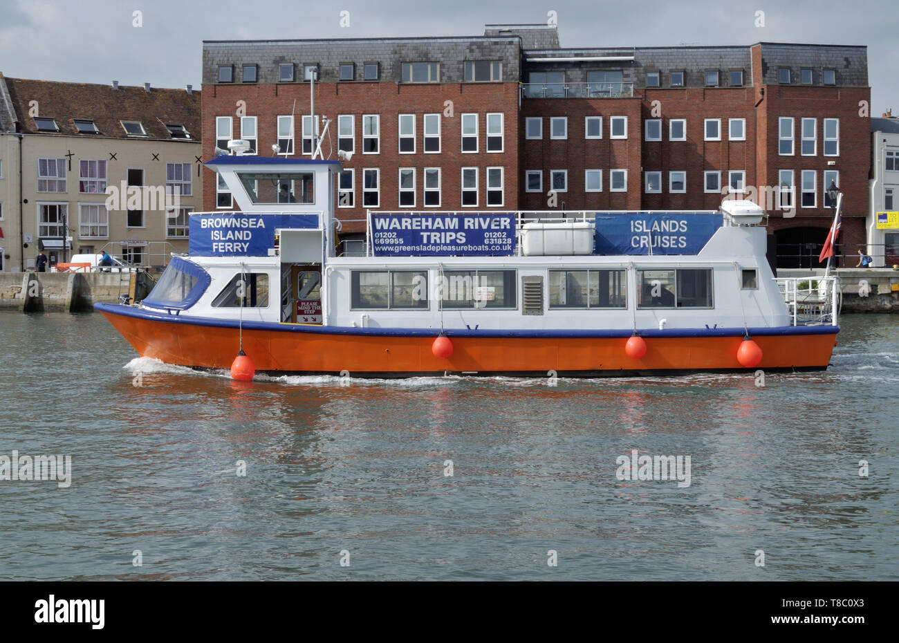 A pleasure boat makes its way past Poole Quay, Poole, Dorset Stock ...