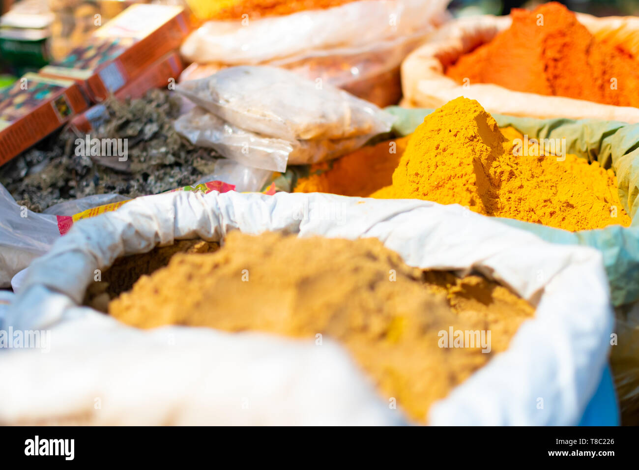 Colorful curry a pepper spices powders and herbs in traditional street ...