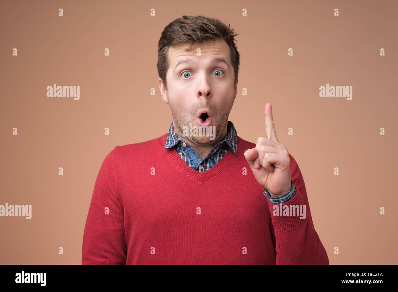 Handsome guy pointing finger up hi-res stock photography and images - Alamy