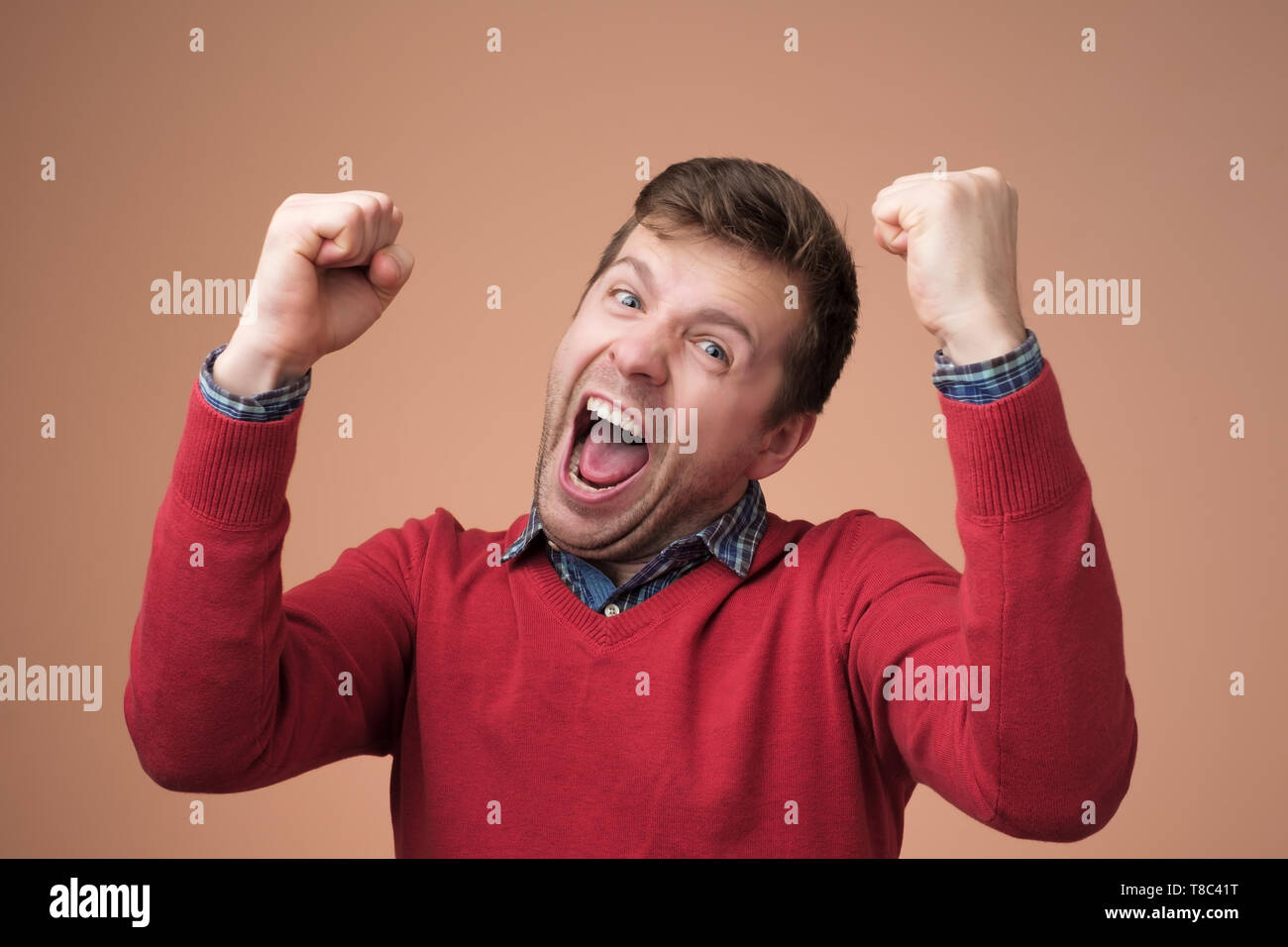 happy man raising hands up being happy and excited Stock Photo - Alamy