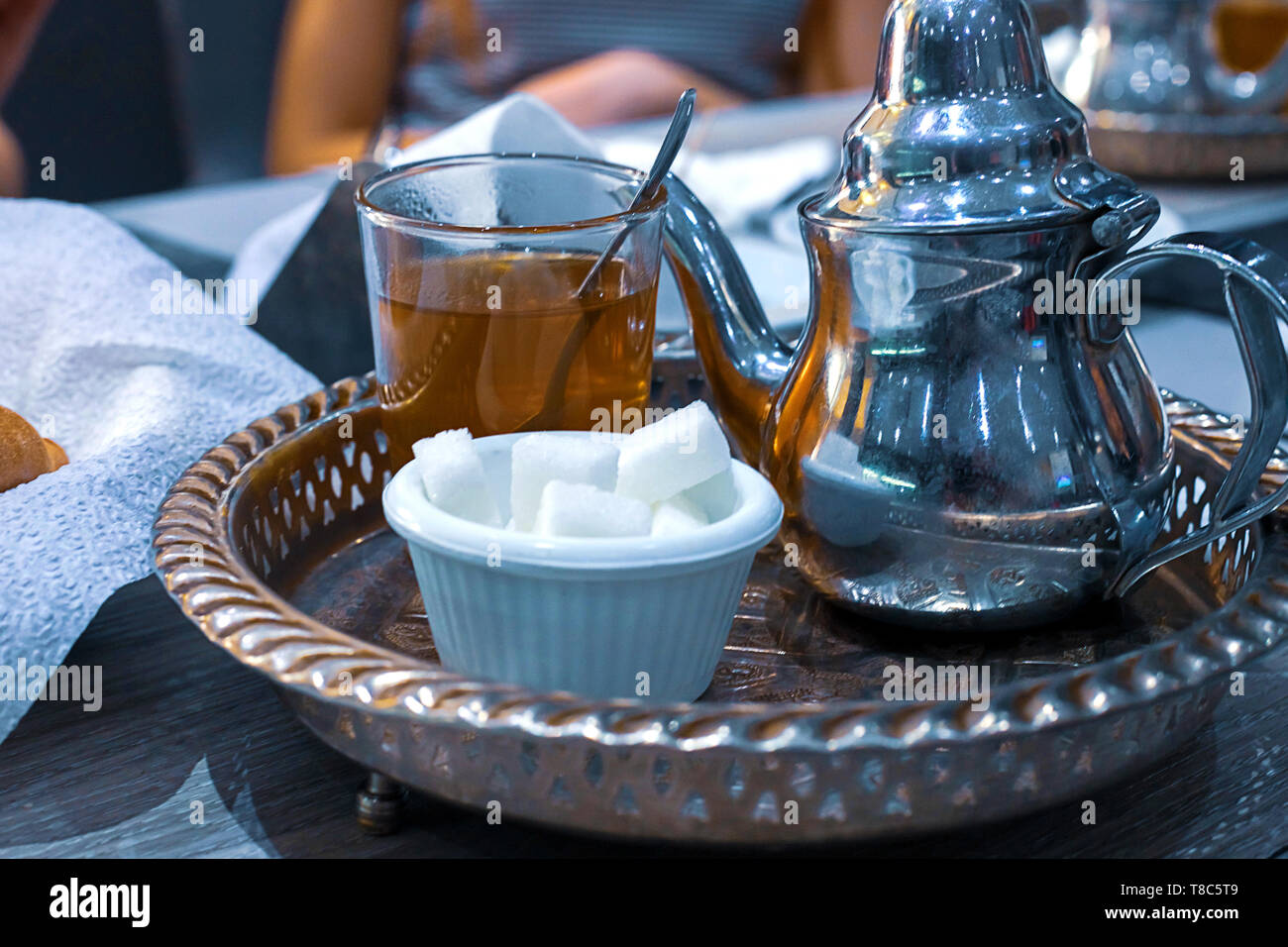 Moroccan tea with mint and sugar in a glasses on a copper plate with ...