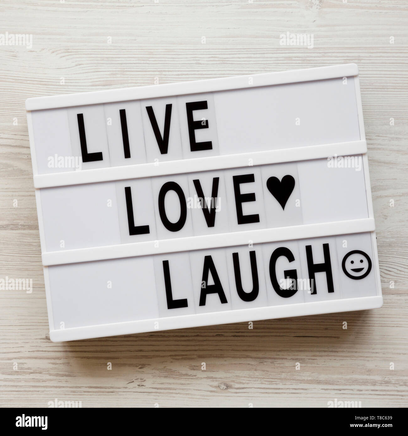 "Live Love Laugh' words on modern board over white wooden background ...