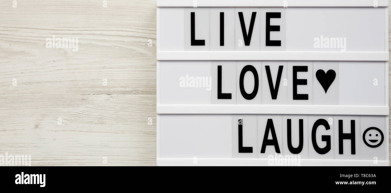 "Live Love Laugh' words on lightbox over white wooden surface, overhead ...