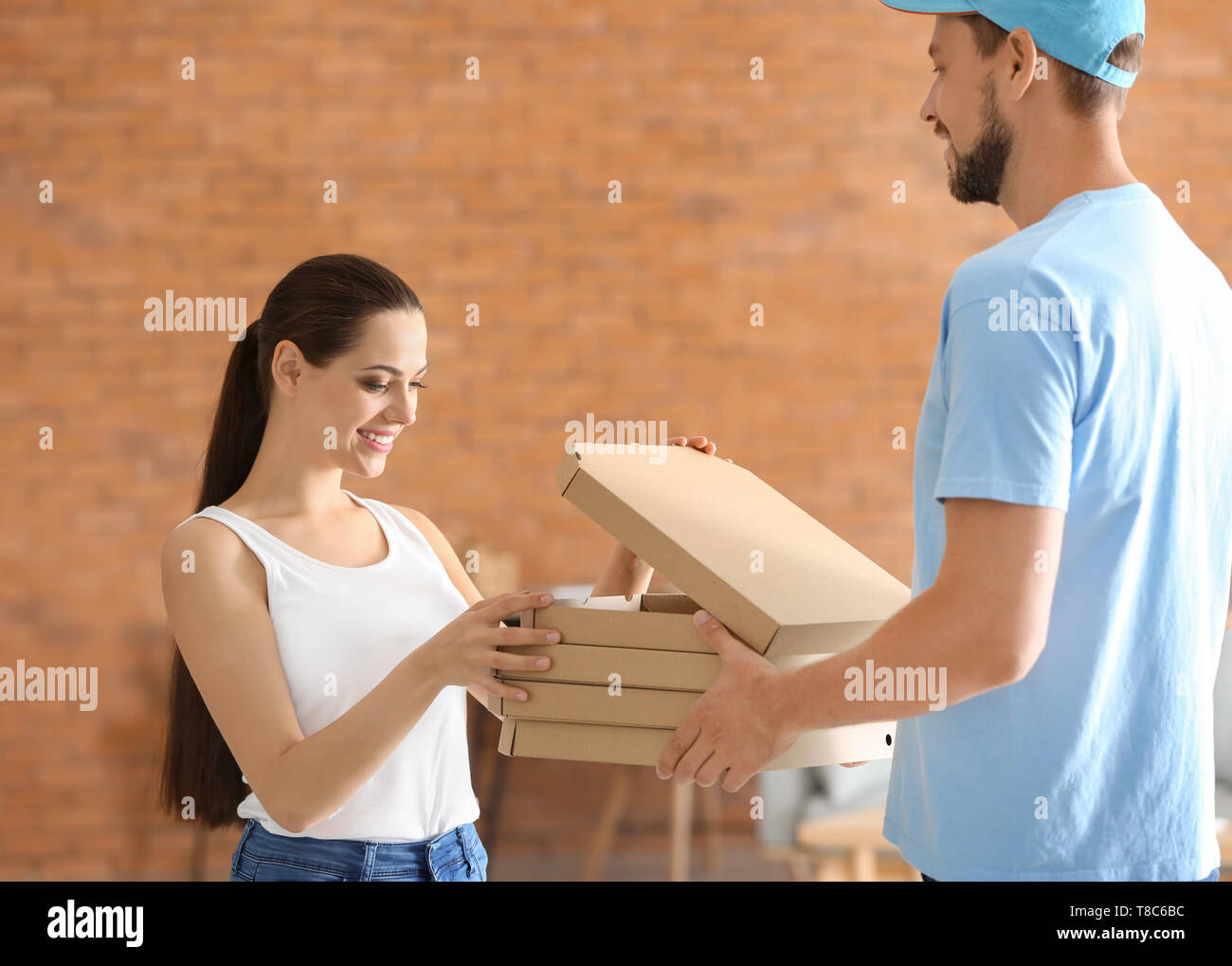 Female customer receiving pizza hi-res stock photography and images - Alamy